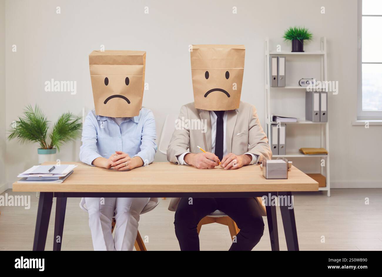 Business Colleagues In Office With Paper Bags On Heads Depicting Bad ...