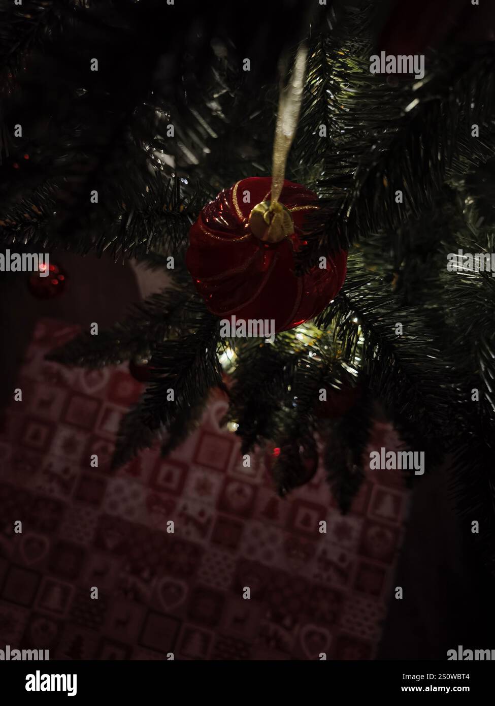 Red and gold christmas ball hanging on a christmas tree with a festive ...