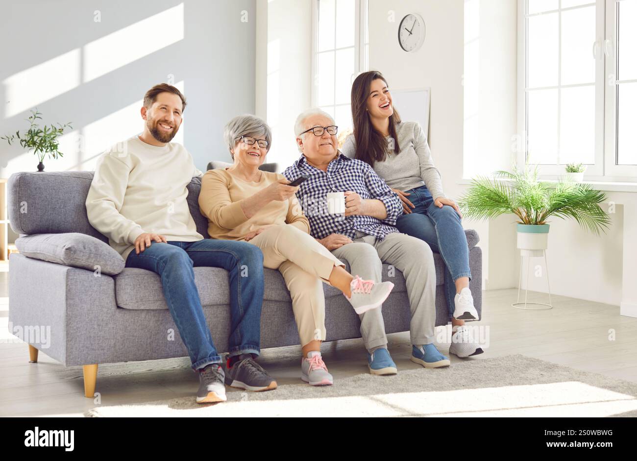 Happy family at home, senior old parents and adult children sitting on ...
