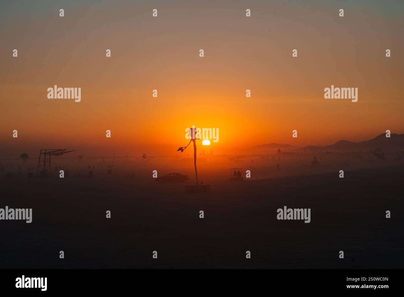 Desert Sunset with Silhouetted Art Installation at Festival Stock Photo ...