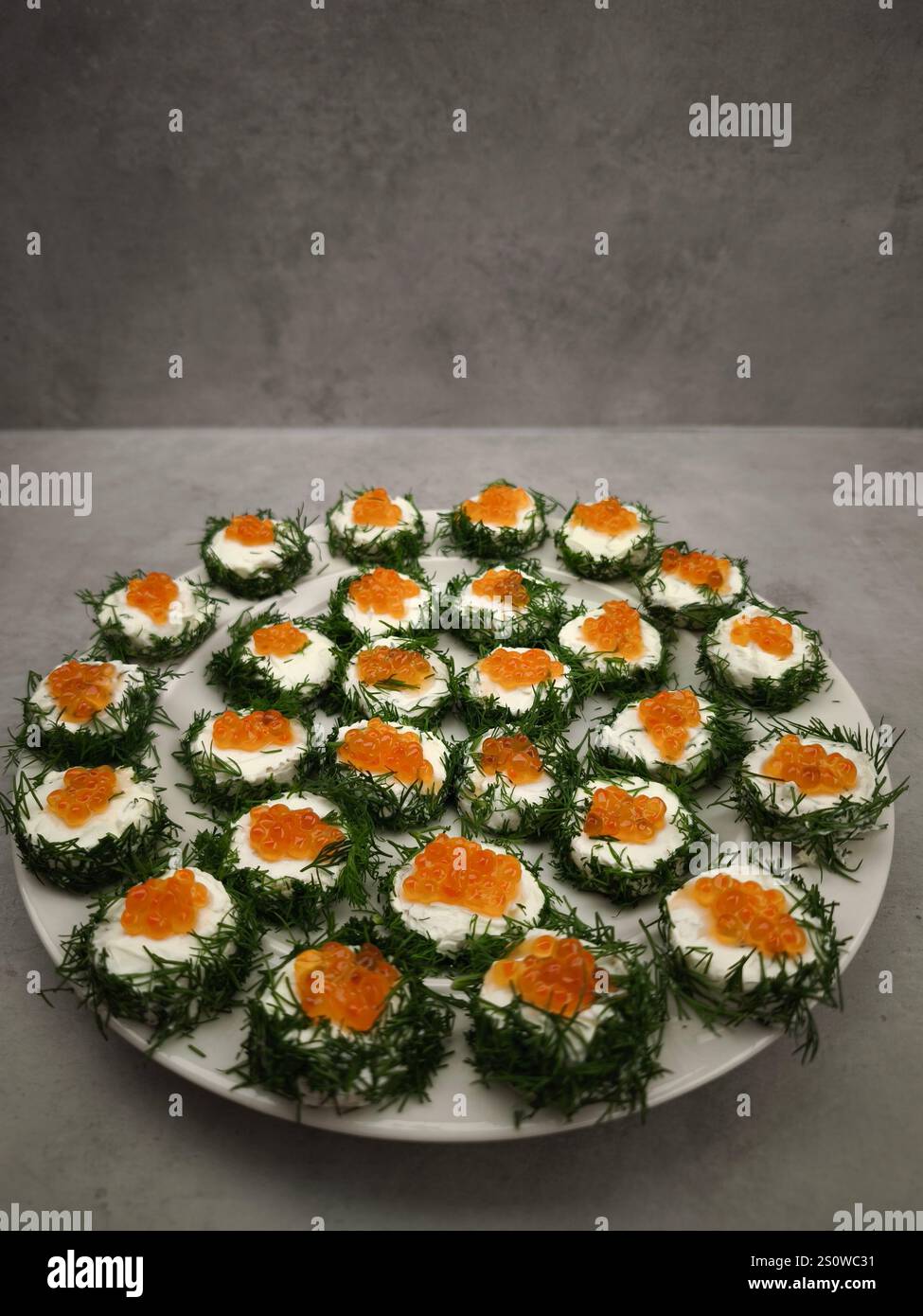 Delicious christmas canapes with red caviar and dill on cream cheese ...
