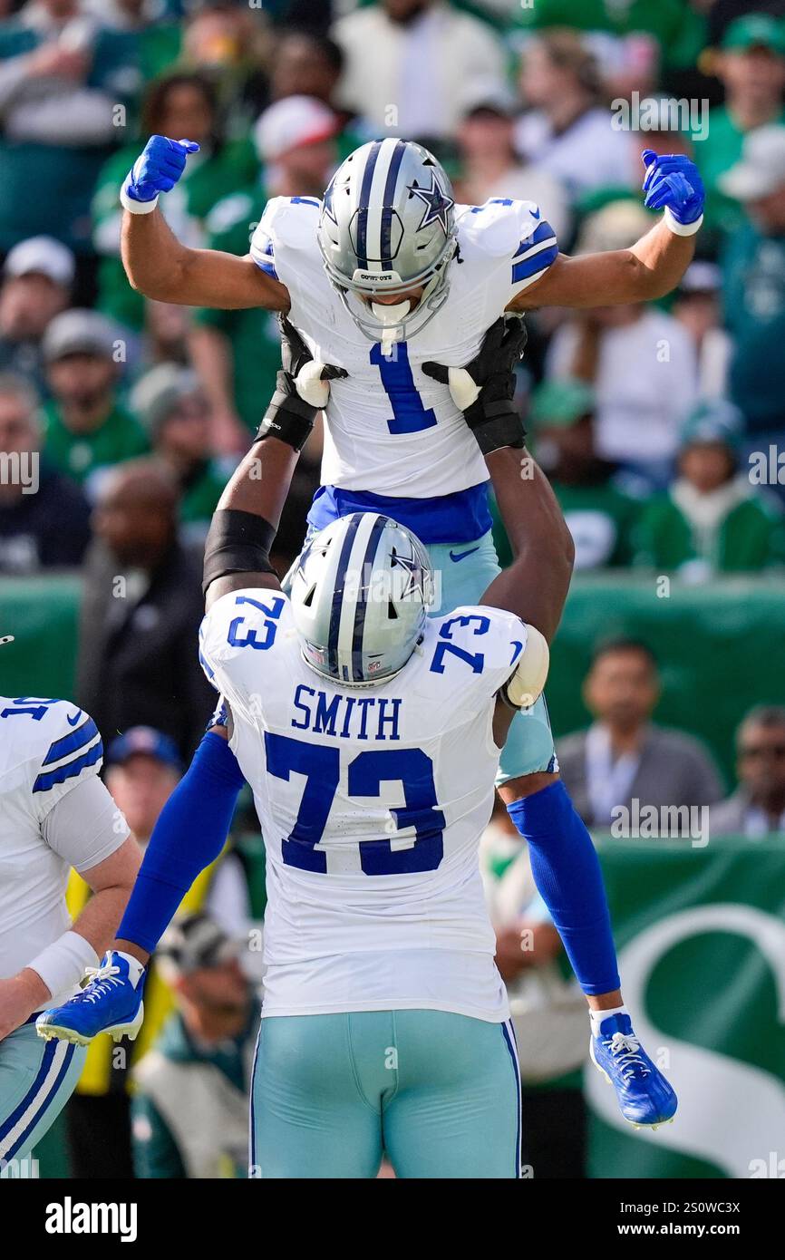 Dallas Cowboys wide receiver Jalen Tolbert (1) is hoisted by teammate ...