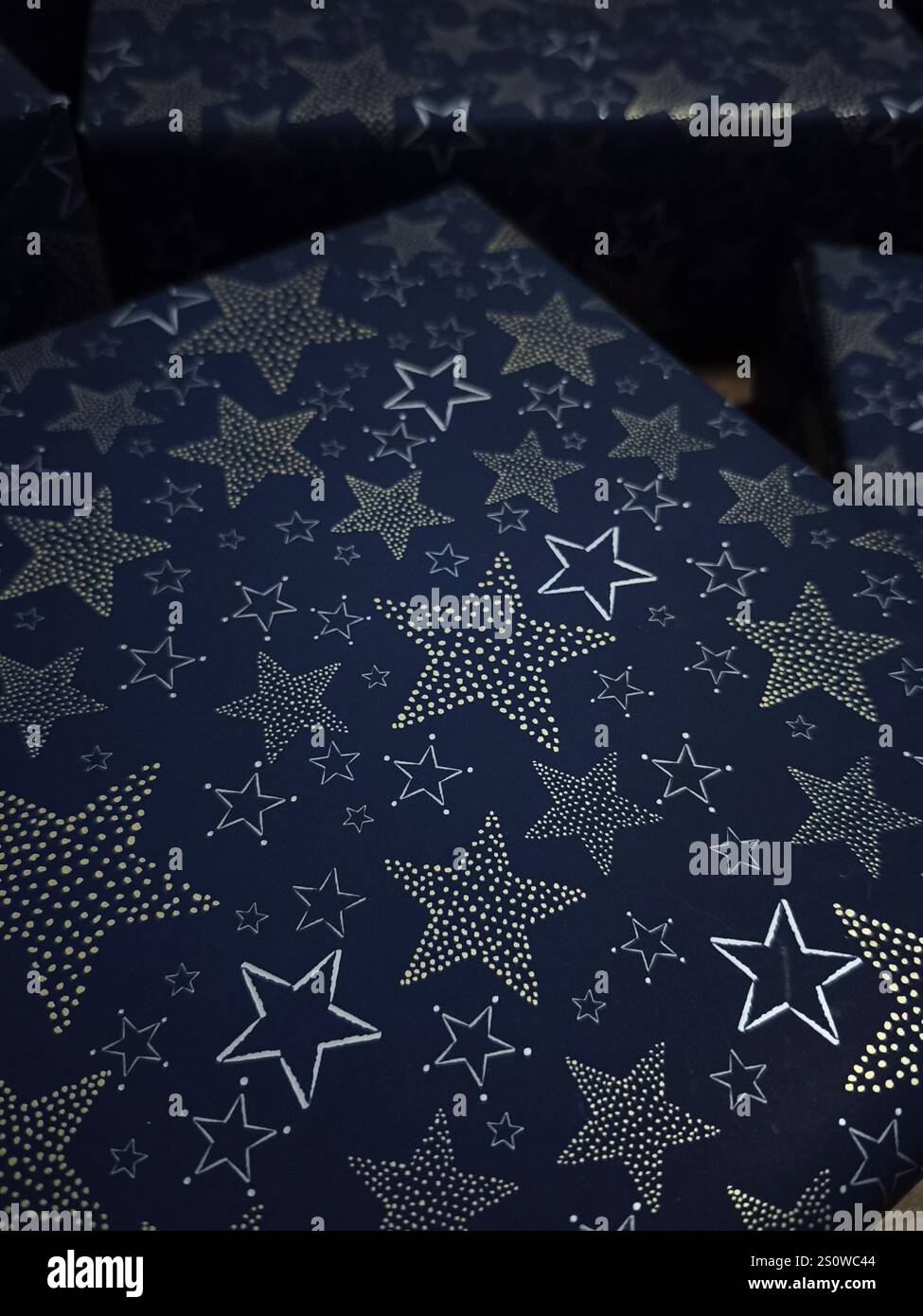 Christmas presents wrapped in elegant navy blue wrapping paper ...