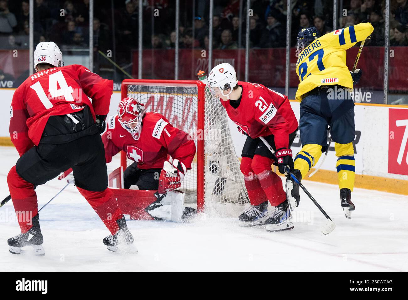241229 David Granberg of Sweden scores 1-4 behind goaltender Christian ...