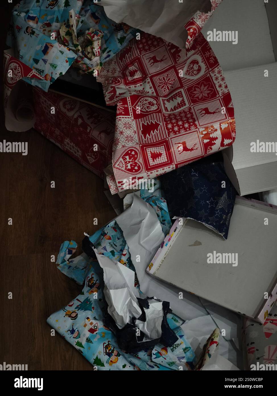 Christmas mess, torn wrapping paper littering the floor after gift ...