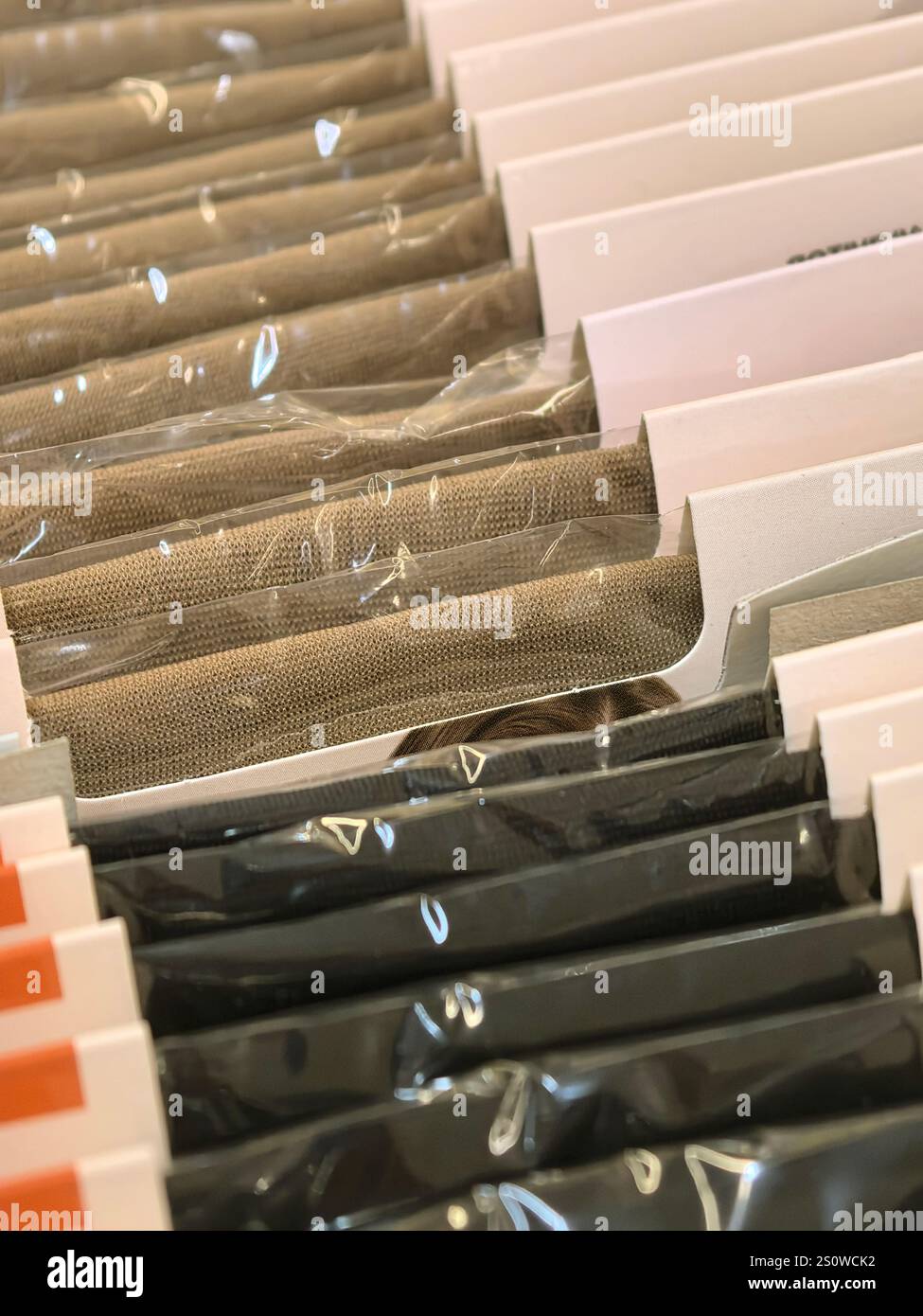 A neatly arranged selection of boxed capron stockings in various colors ...