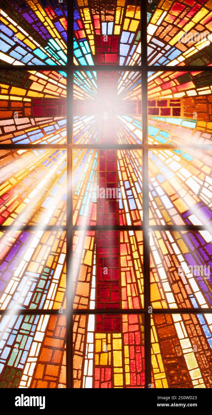 Sun rays coming from the center of a stained glass window with a cross ...