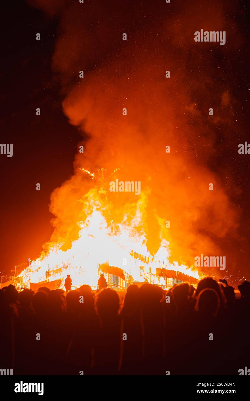 Large Bonfire at Night with Silhouetted Crowd in Black Rock Desert ...