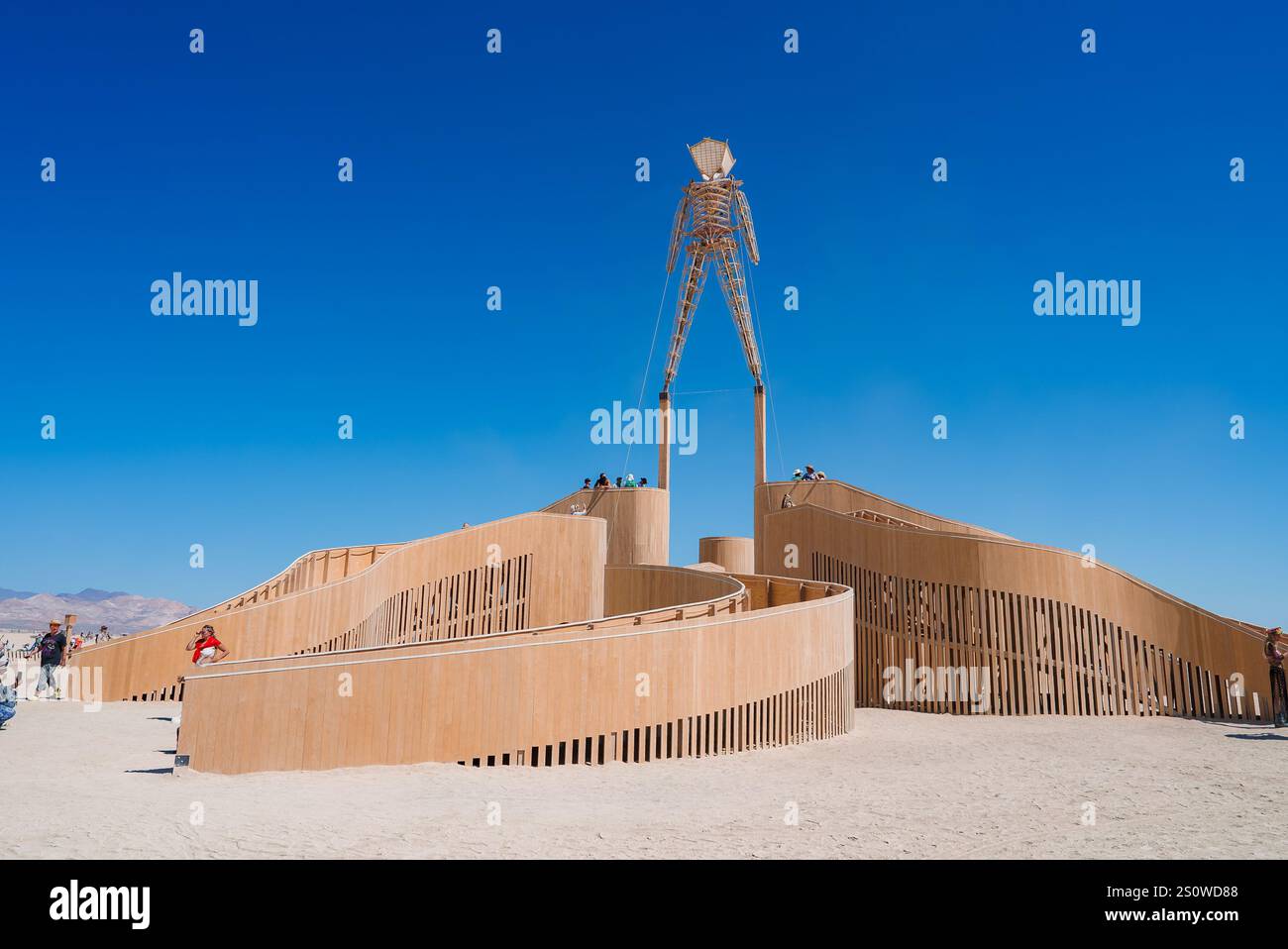 A large wooden structure, The Man, stands on a platform with ramps ...