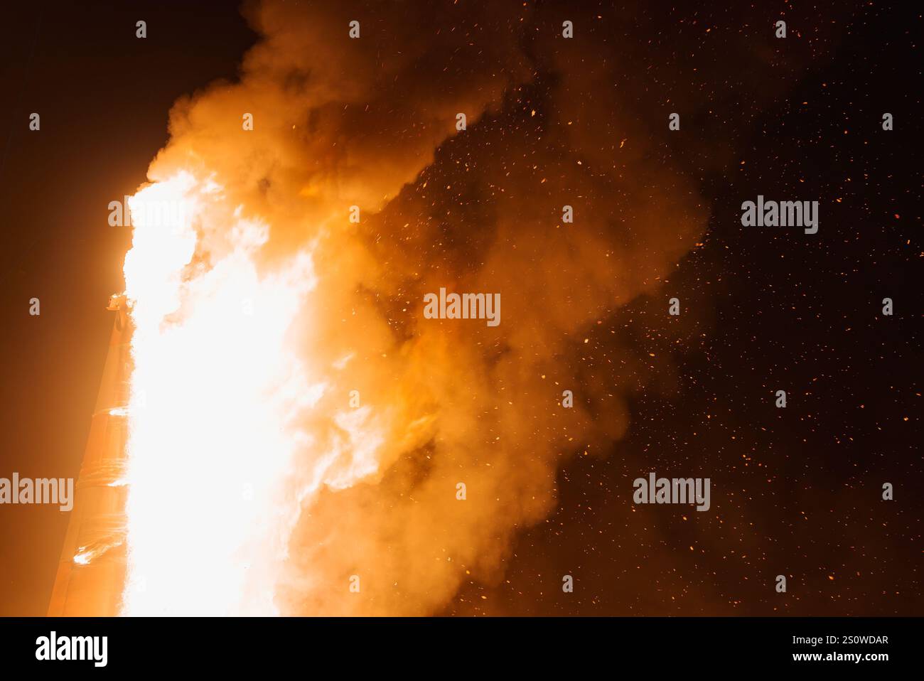 A dramatic scene of a large fire with flames and smoke rising into the ...