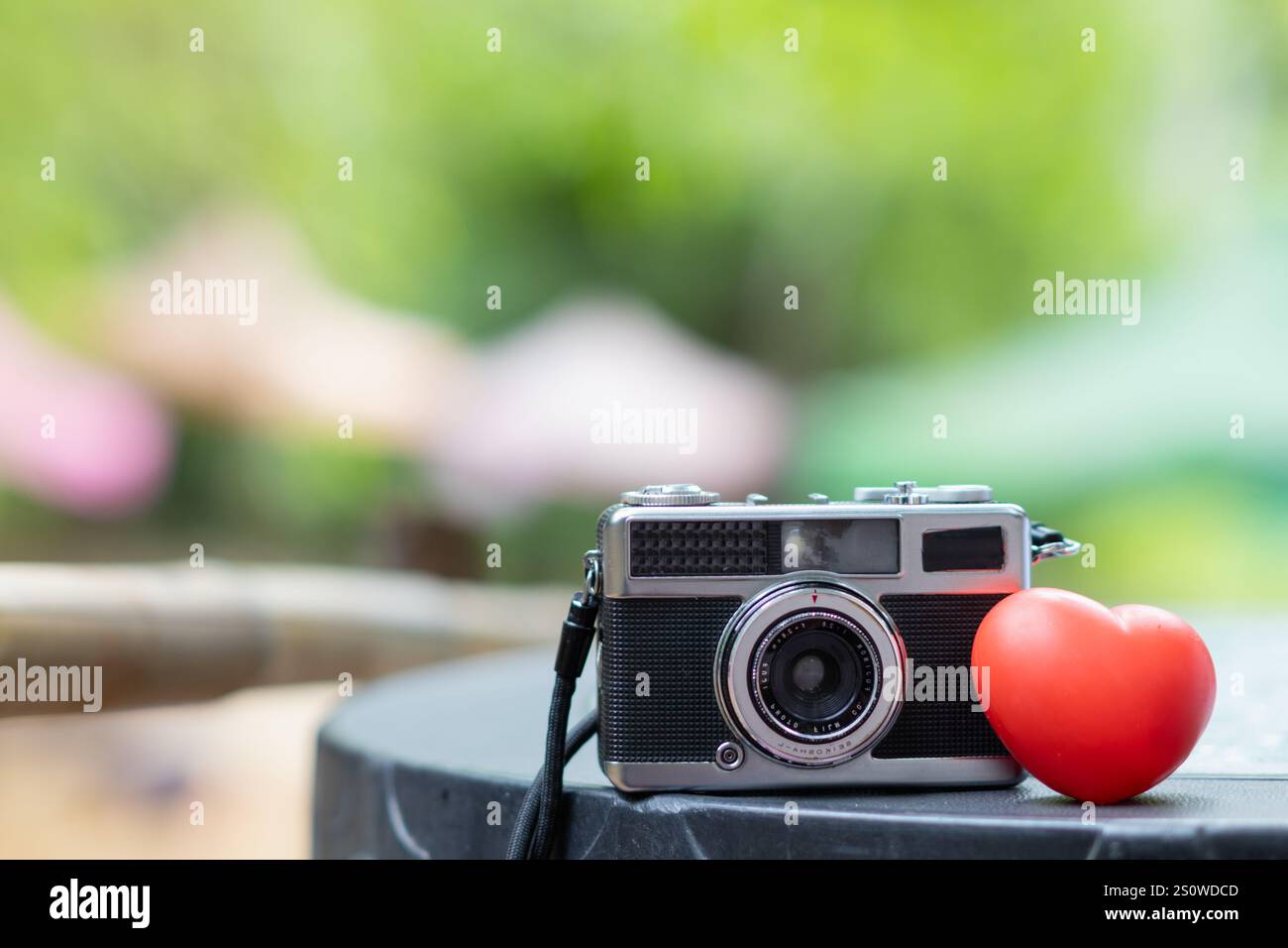 Film cameras and red heart symbol are placed on photographer desk to ...
