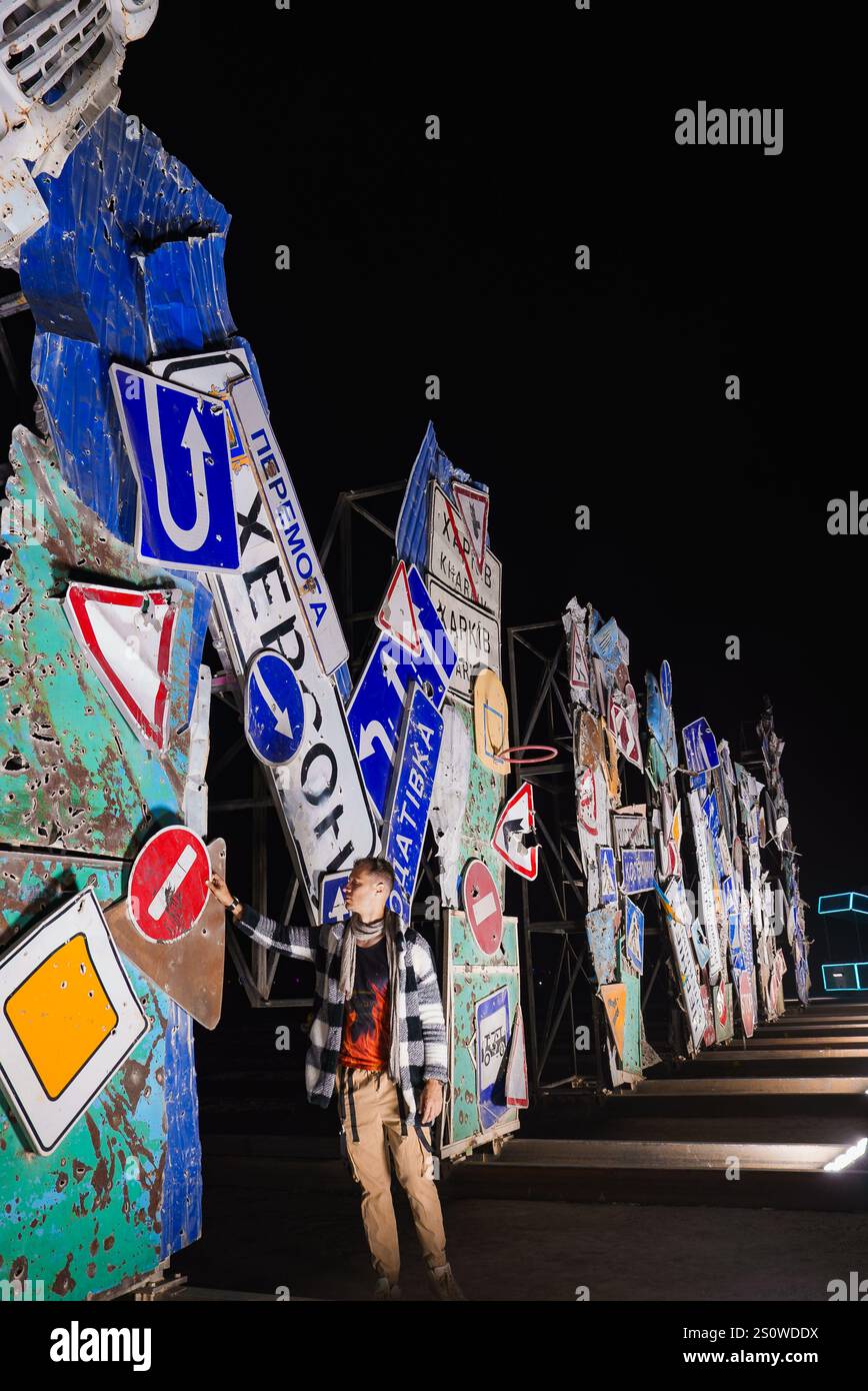 A participant stands before a chaotic arrangement of illuminated road ...
