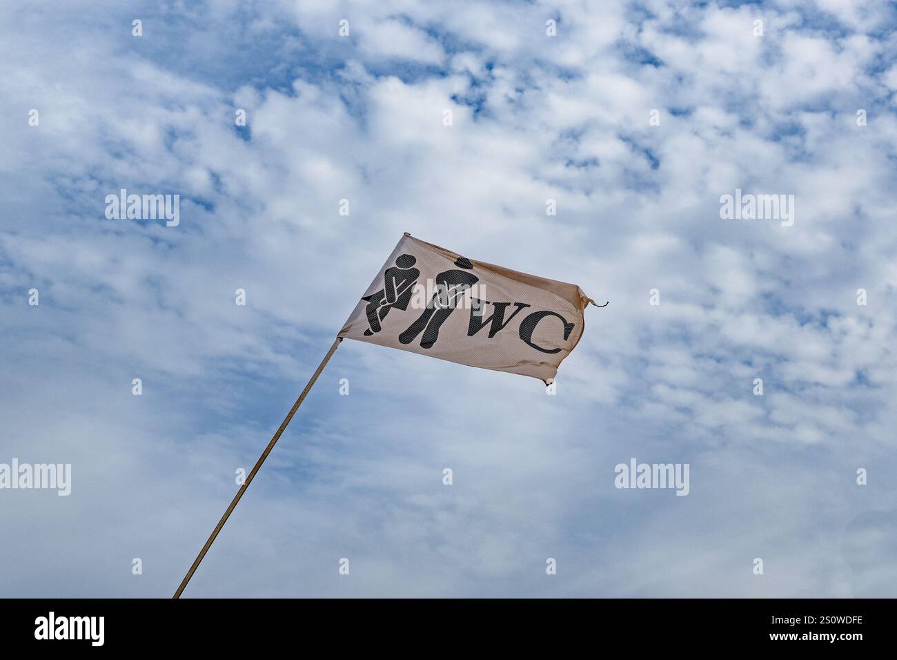 Funny Female and male toilet sign on a flag waving in the wind against ...