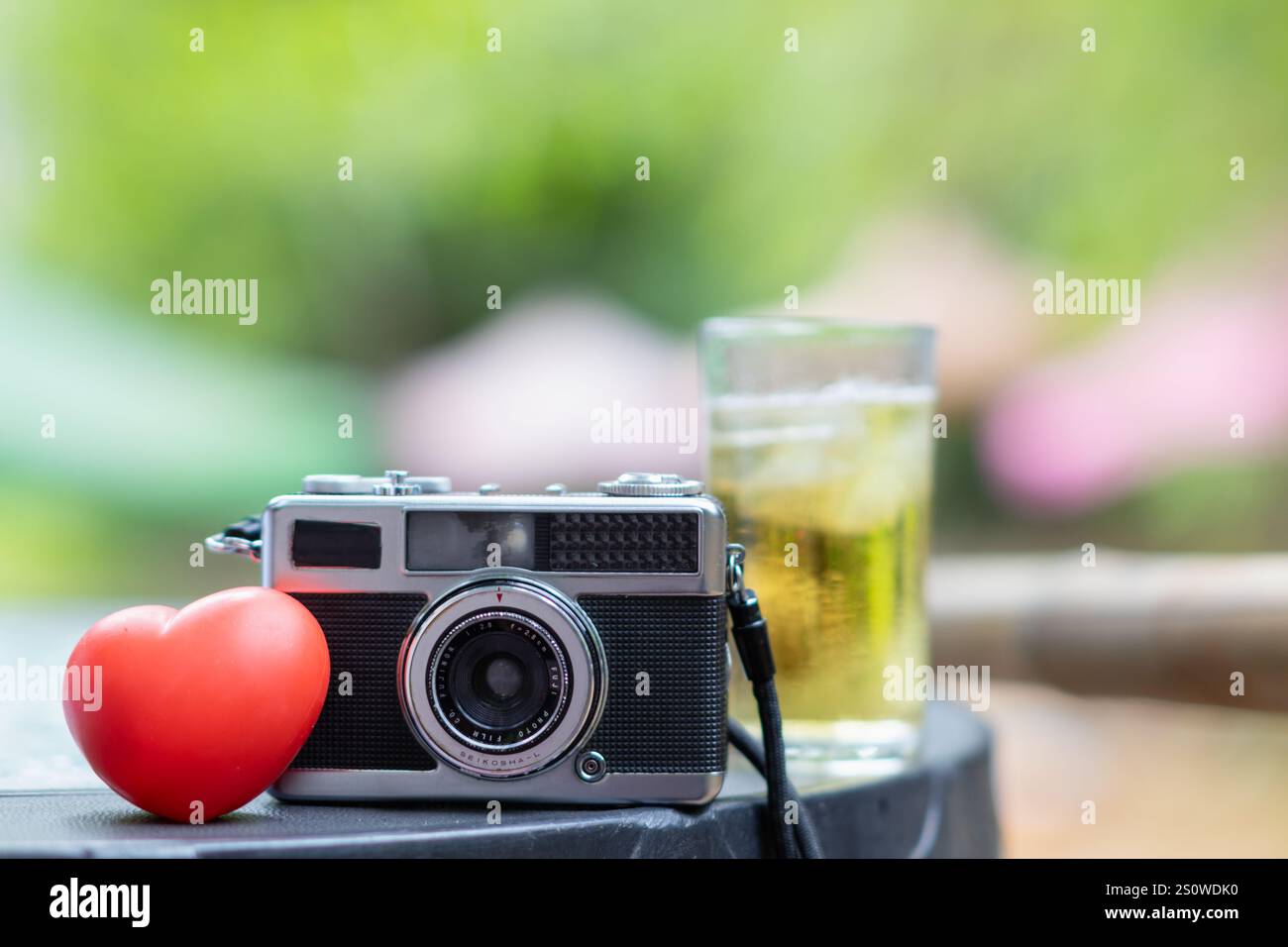 Film cameras and red heart symbol are placed on photographer desk to ...