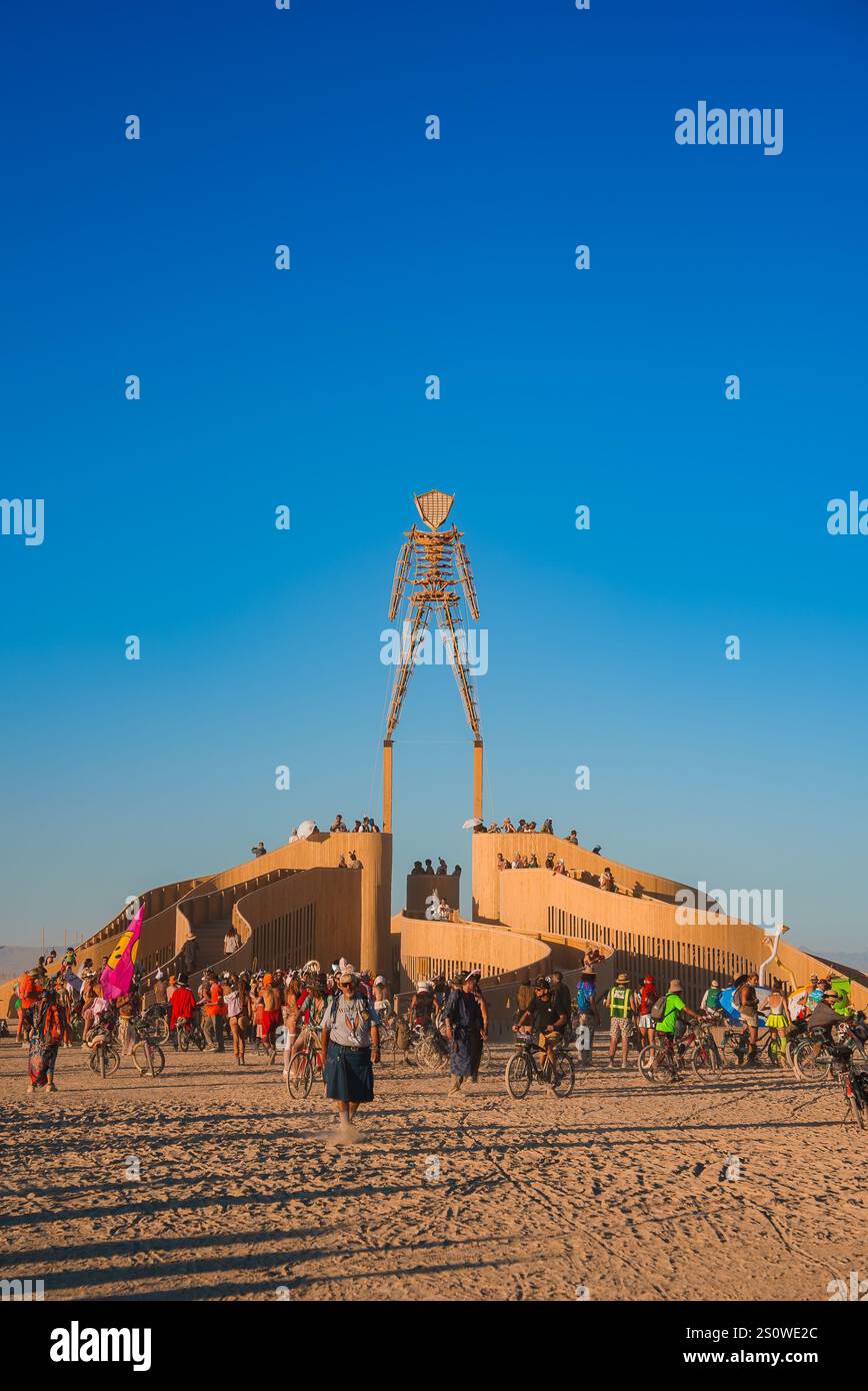 A large wooden structure resembling a human figure stands on a platform ...