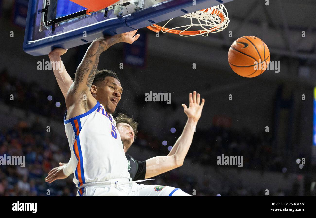 Florida guard Will Richard (5) dunks under pressure from Stetson ...