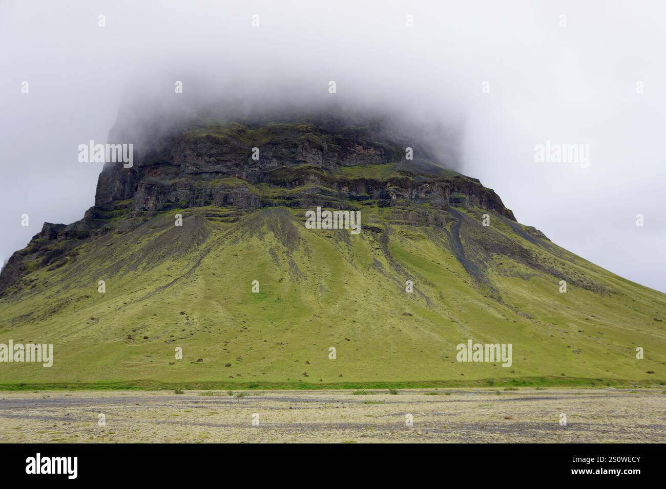 Clouds touch the green-covered ground on Iceland Stock Photo - Alamy