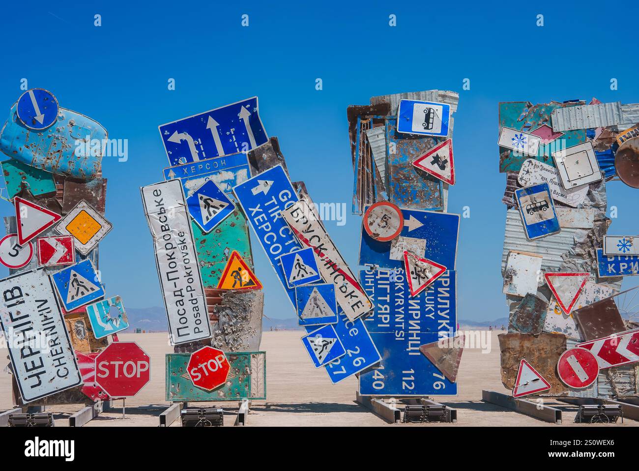 A collection of road signs, including stop signs and directional arrows ...