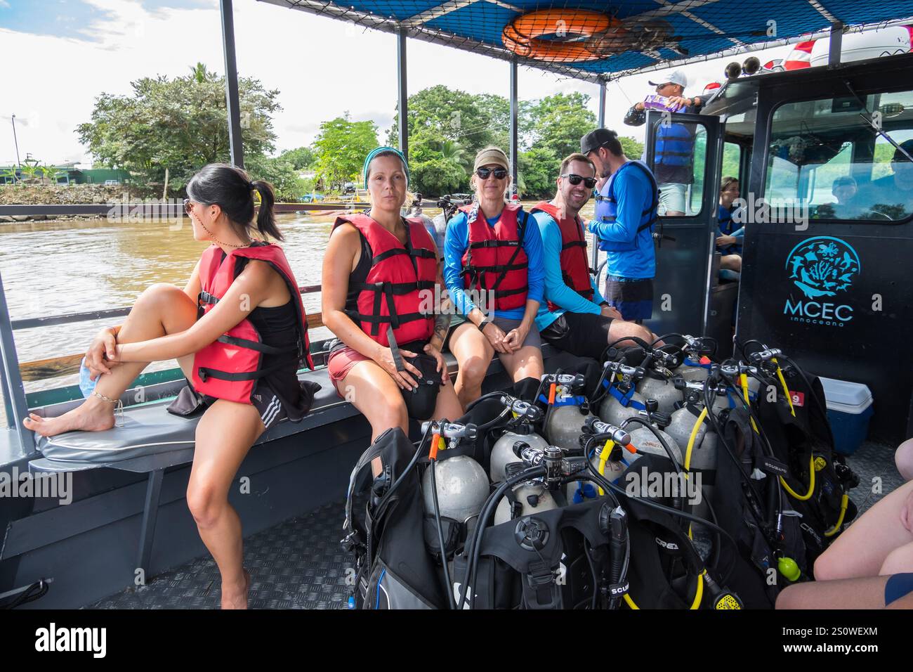 Group of divers and their equipment inside a boat sailing through the ...