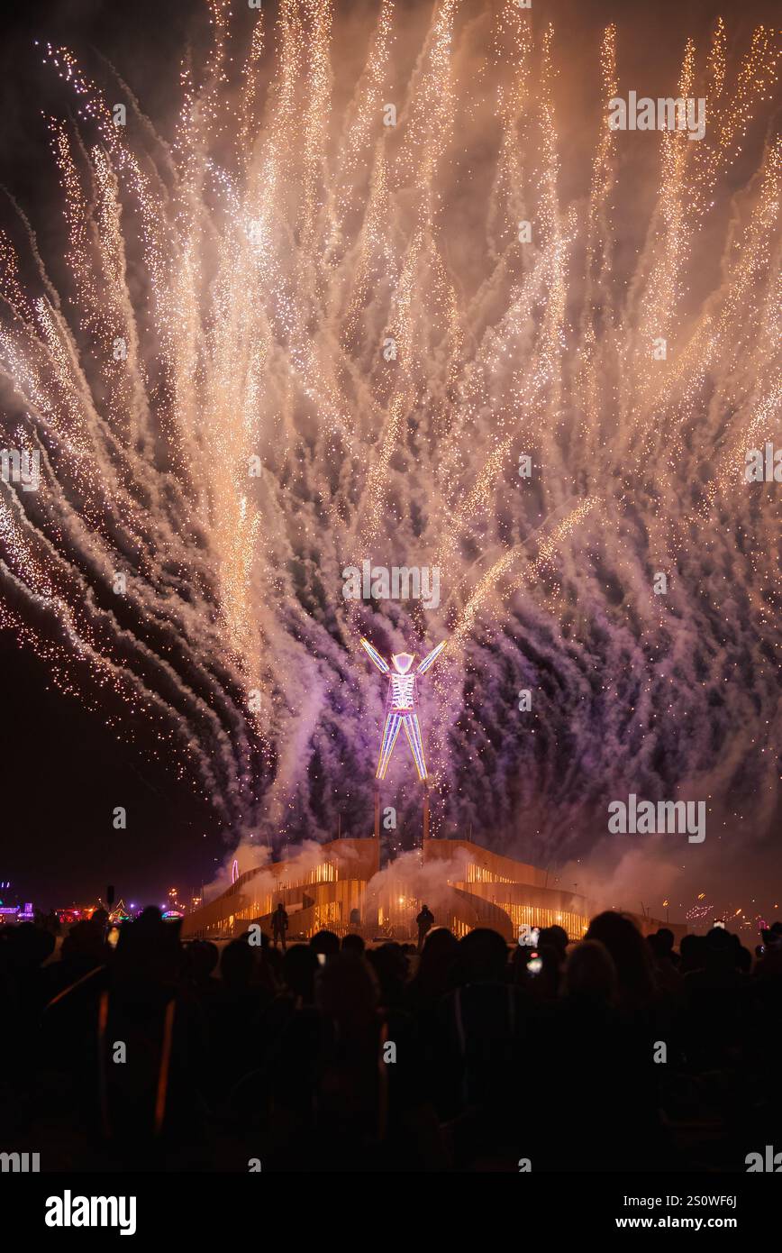 A large wooden effigy, known as The Man, is illuminated against the ...