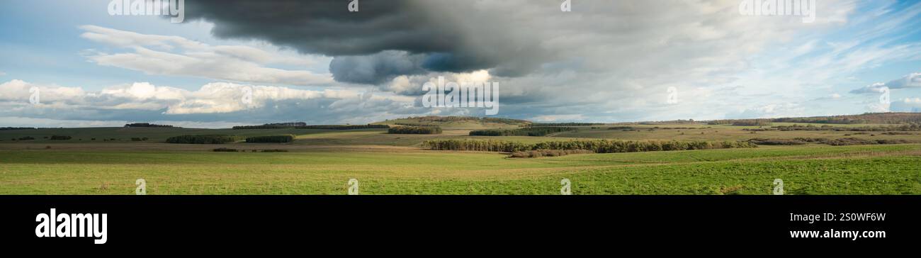 a dark black shelf cloud in a foreboding sky bringing heavy rain over ...