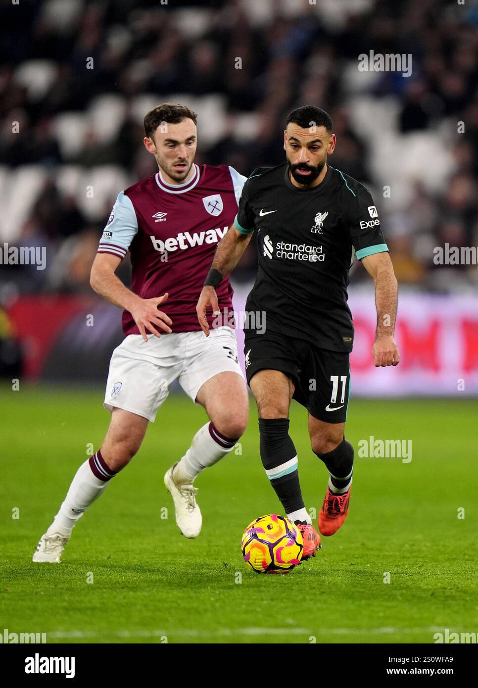 West Ham United's Andy Irving (left) and Liverpool's Mohamed Salah ...
