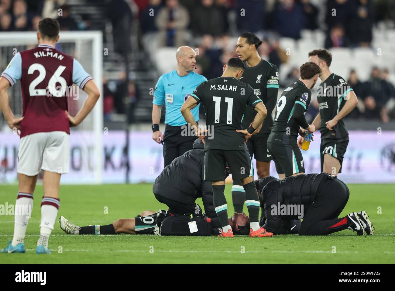 Alexis Mac Allister of Liverpool receives treatment during the Premier ...