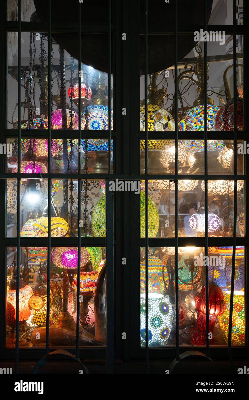 Colorful glass lamps and chandeliers on display in a shop window Stock ...
