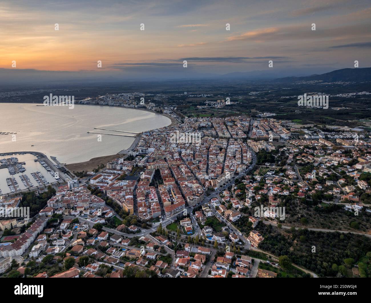 Aerial view of the city of Roses at a reddish sunset (Alt Empordà ...