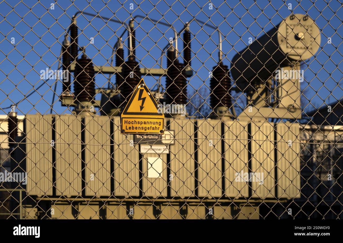 High-voltage warning sign, danger to life, in front of capacitors in ...