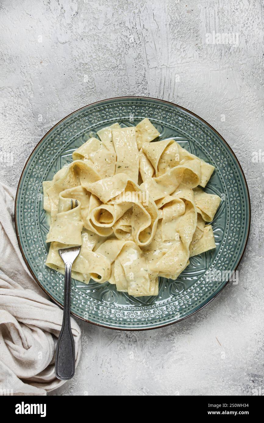 Pasta papardelle in creamy garlic sauce, traditional Italian cuisine ...