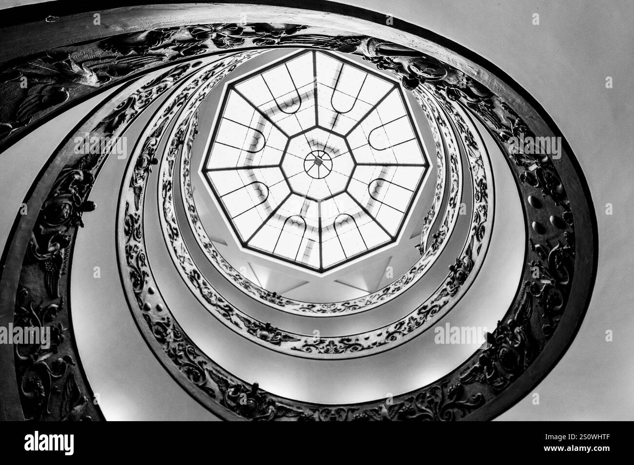 Black and white spiral staircase from below with ornate banisters, Rome ...