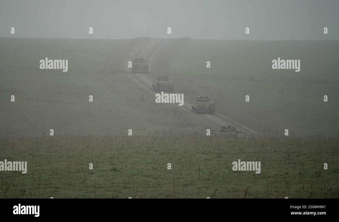a squadron of British army Warrior FV510 IFV tanks in action, driving ...