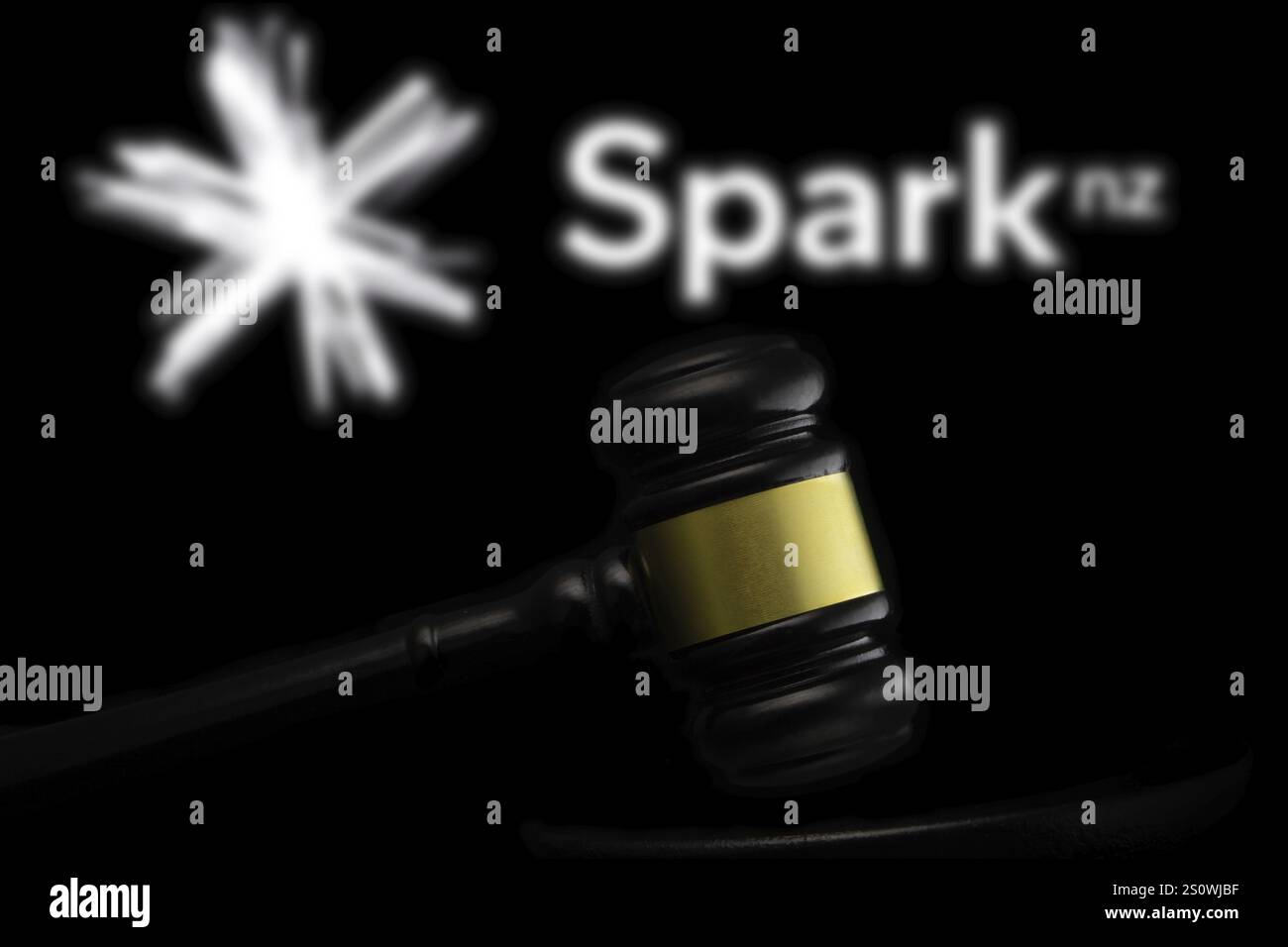 Court gavel in front of the Spark nz logo. Spark New Zealand Limited is ...