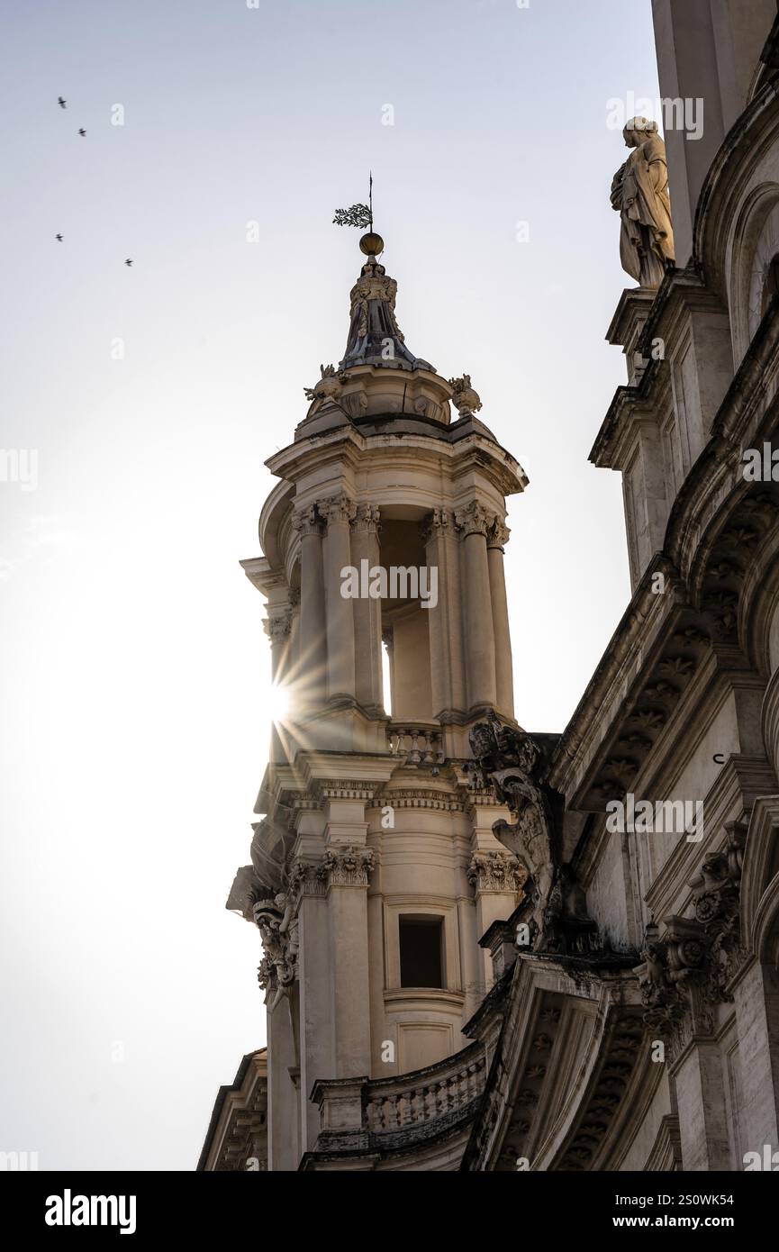 Baroque architecture with a tower and sunlight streaming through the ...