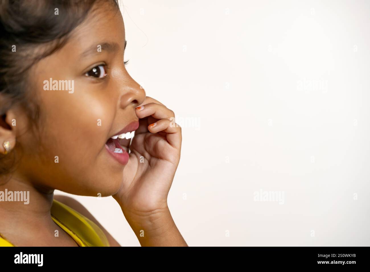 Little girl whispers a secret, adding a touch of mystery and intrigue ...