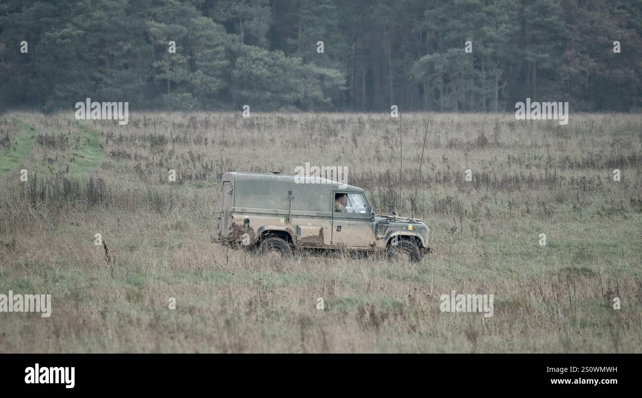 a British army Land Rover Wolf utility vehicle moving through open ...