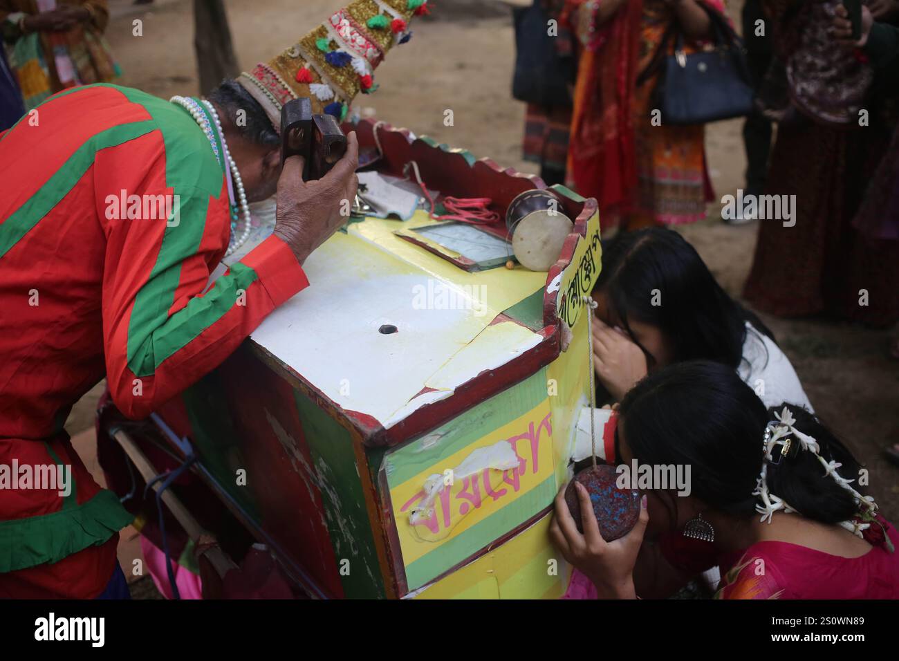 Dhaka, Bangladesh. 30th Dec, 2024. Visitors enjoy a bioscope show at a ...