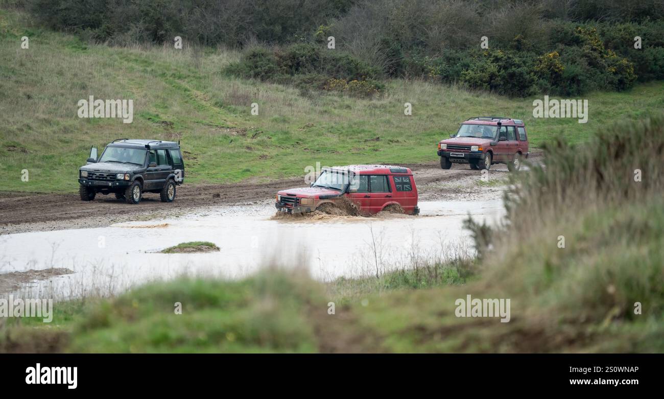 a group of 4x4 land rover discovery series II off-roading and wading ...