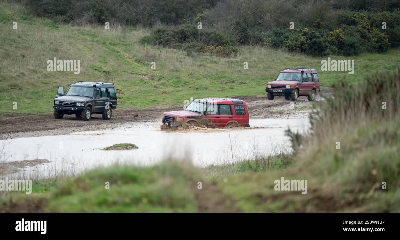 a group of 4x4 land rover discovery series II off-roading and wading ...
