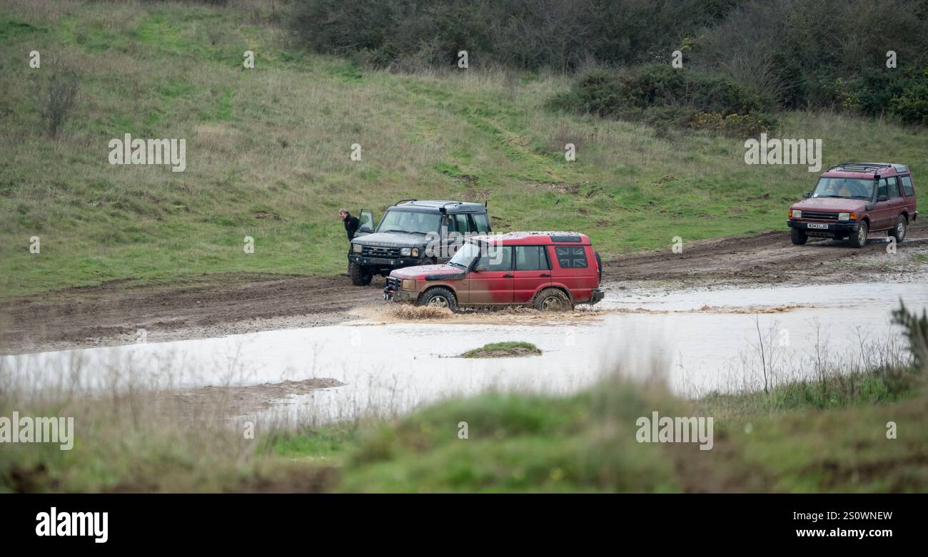 a group of 4x4 land rover discovery series II off-roading and wading ...