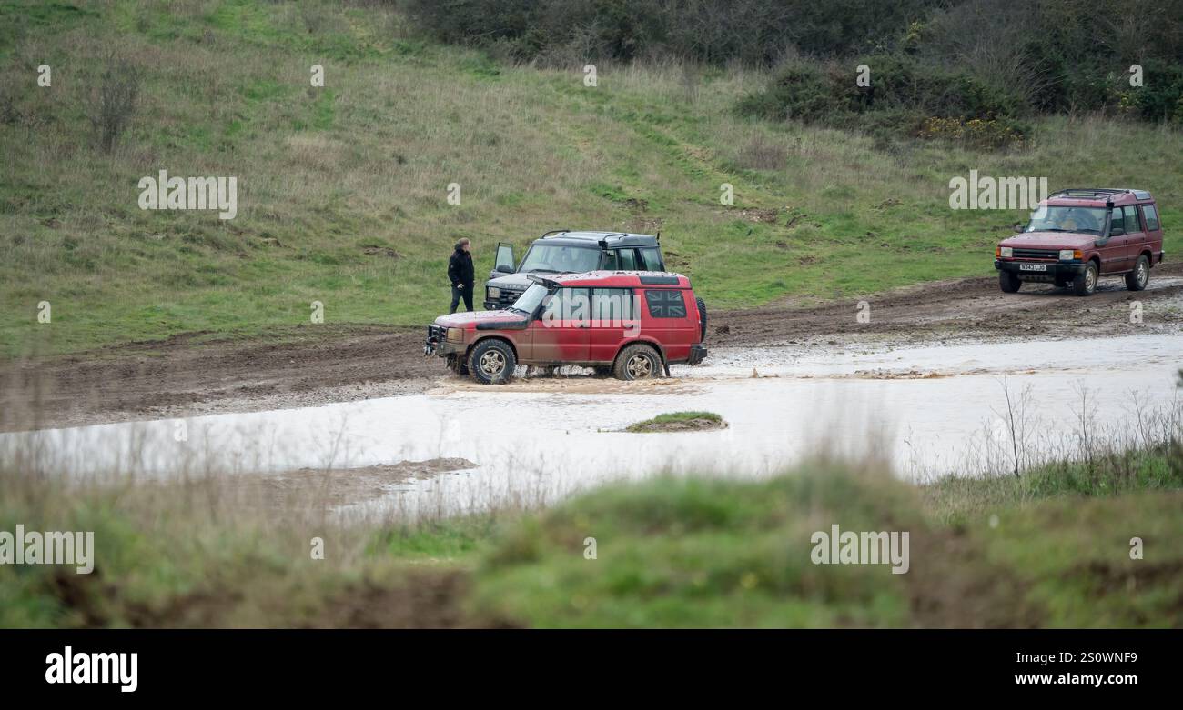 a group of 4x4 land rover discovery series II off-roading and wading ...
