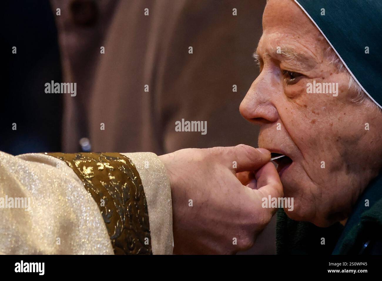 Rome, Italy. 29th Dec, 2024. A nun takes communion during a Mass ...
