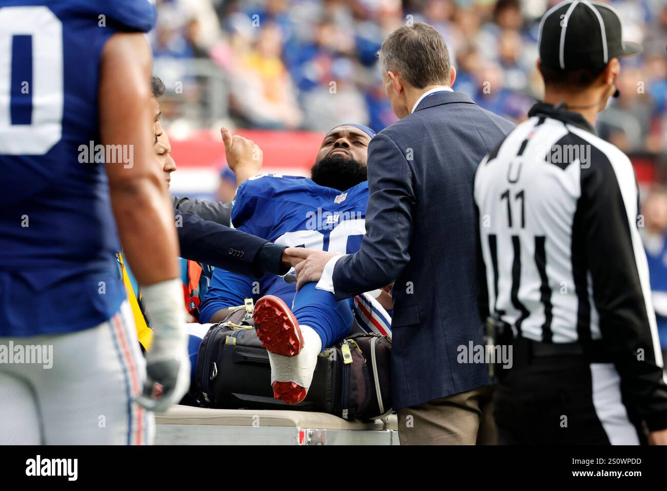 New York Giants defensive tackle Armon Watts (96) is taken off the ...