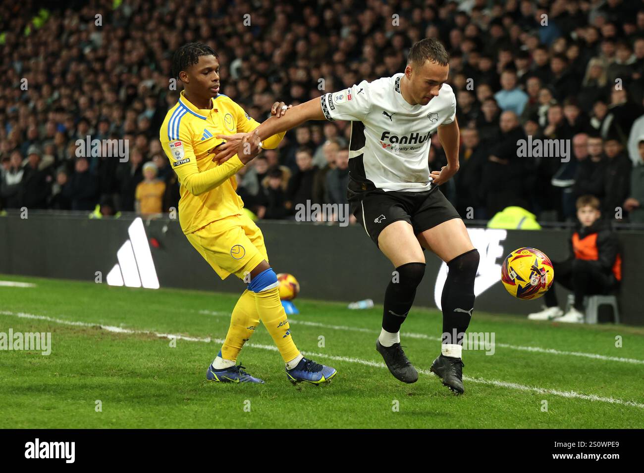 Leeds United's Largie Ramazani (left) and Derby County's Kane Wilson ...