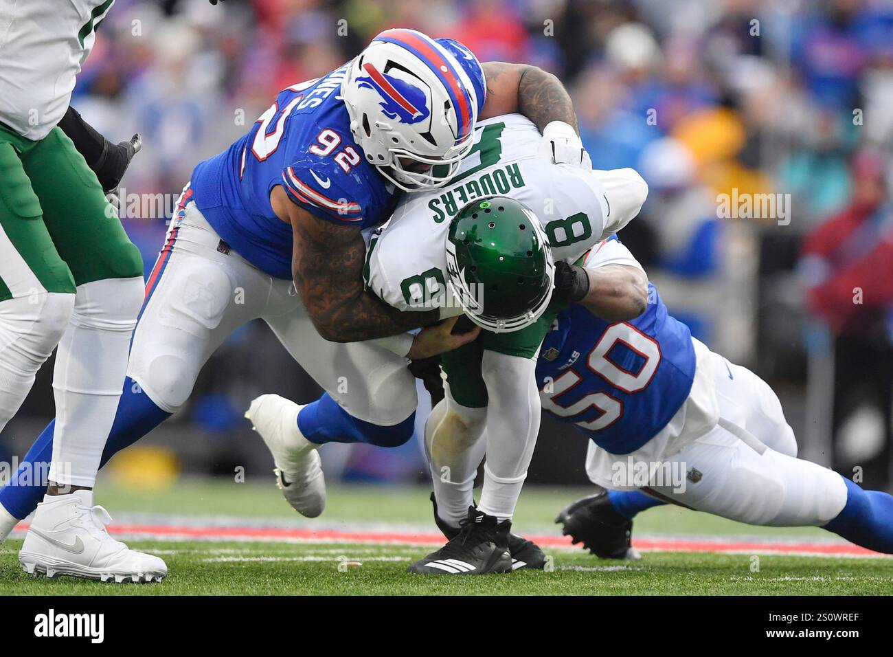 New York Jets quarterback Aaron Rodgers (8) is sacked by Buffalo Bills ...