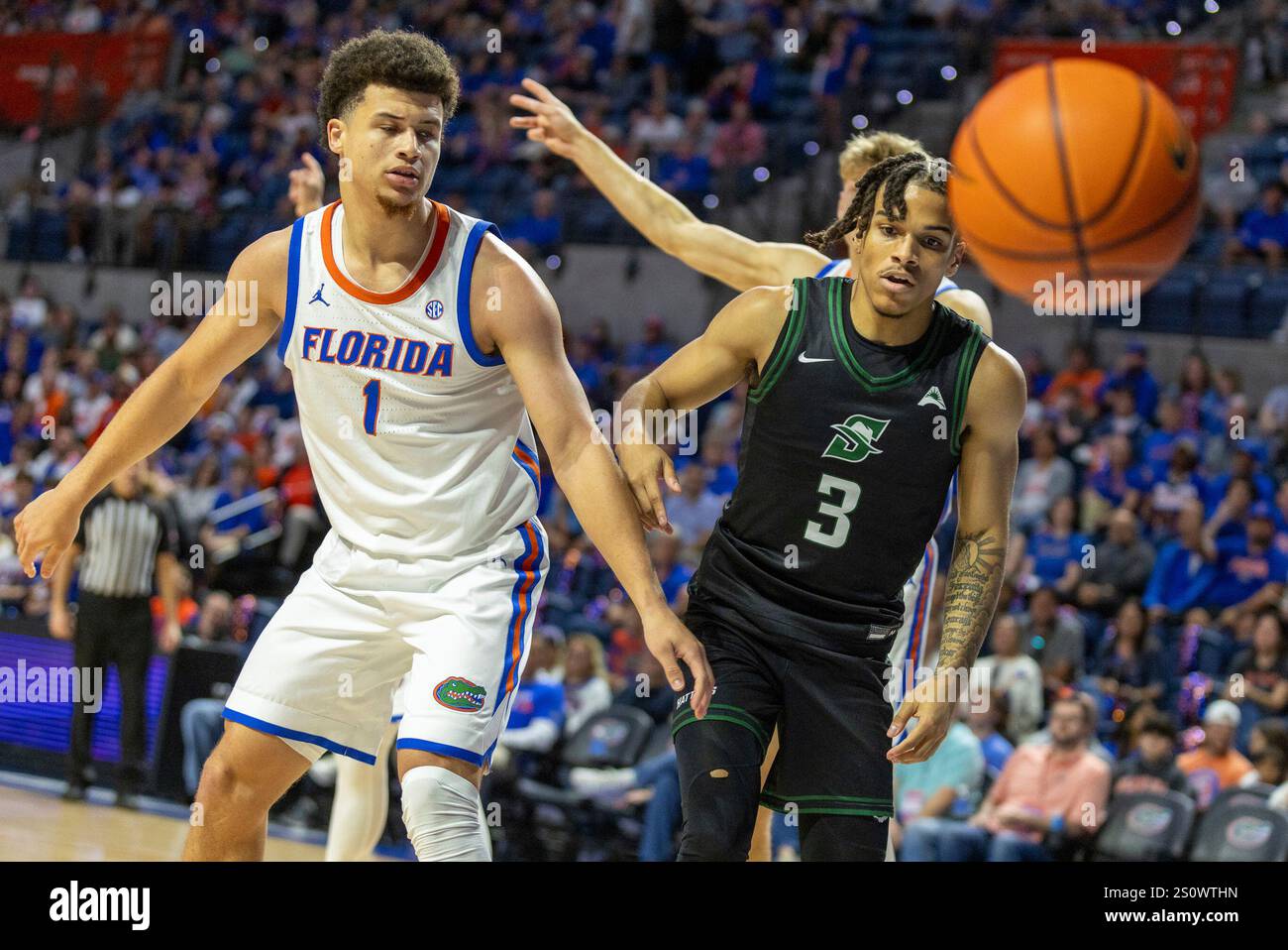 Florida guard Walter Clayton Jr. (1) and Stetson guard Mehki Ellison (3 ...