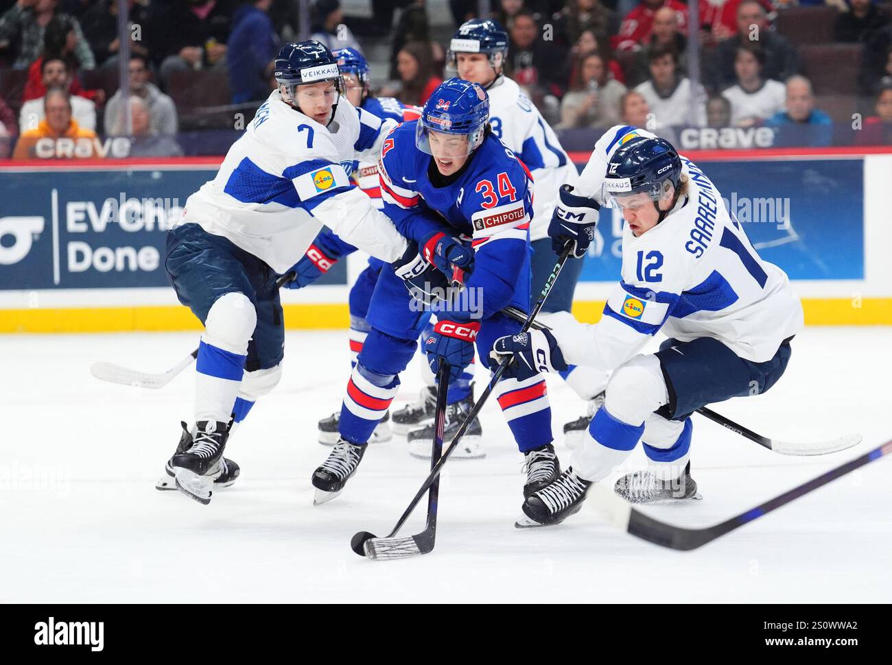 United States forward Gabe Perreault (34) skates with the puck as ...