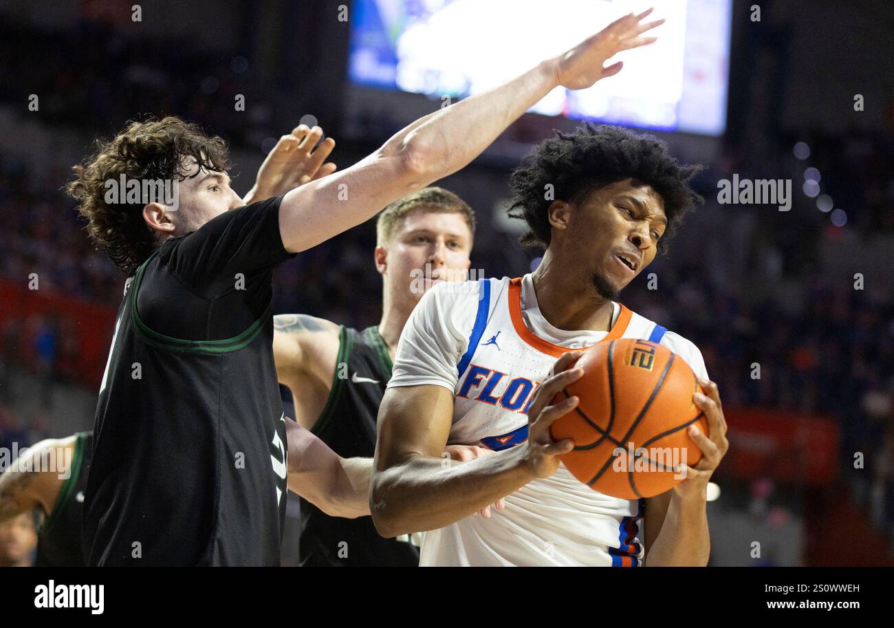 Florida forward Sam Alexis (4) rebounds past Stetson forward Jordan ...