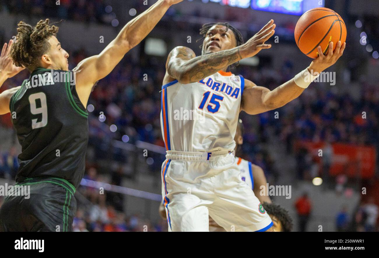 Florida guard Alijah Martin (15) shoots past Stetson guard Blaize Sagna ...